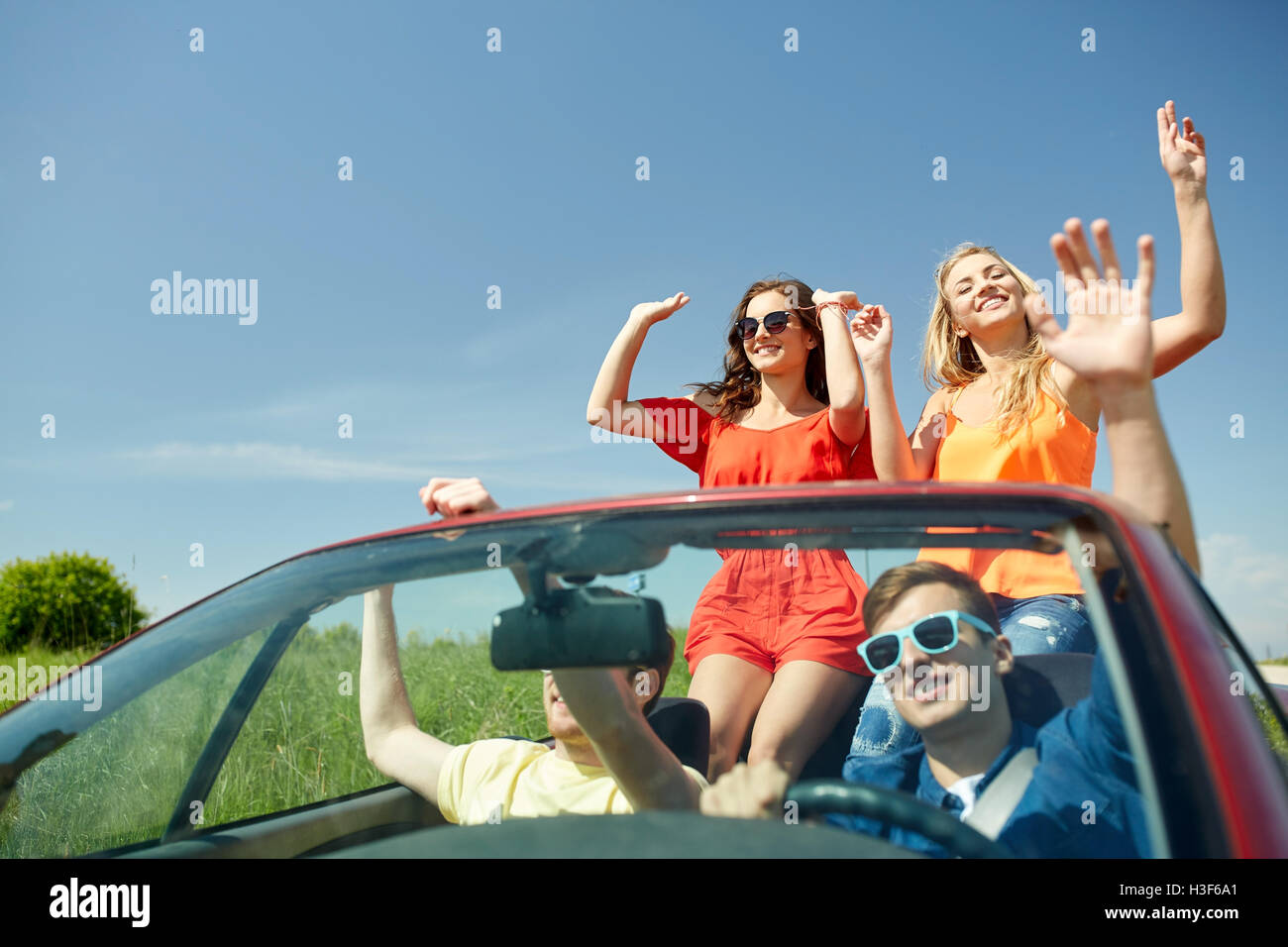 happy friends driving in cabriolet car Stock Photo - Alamy