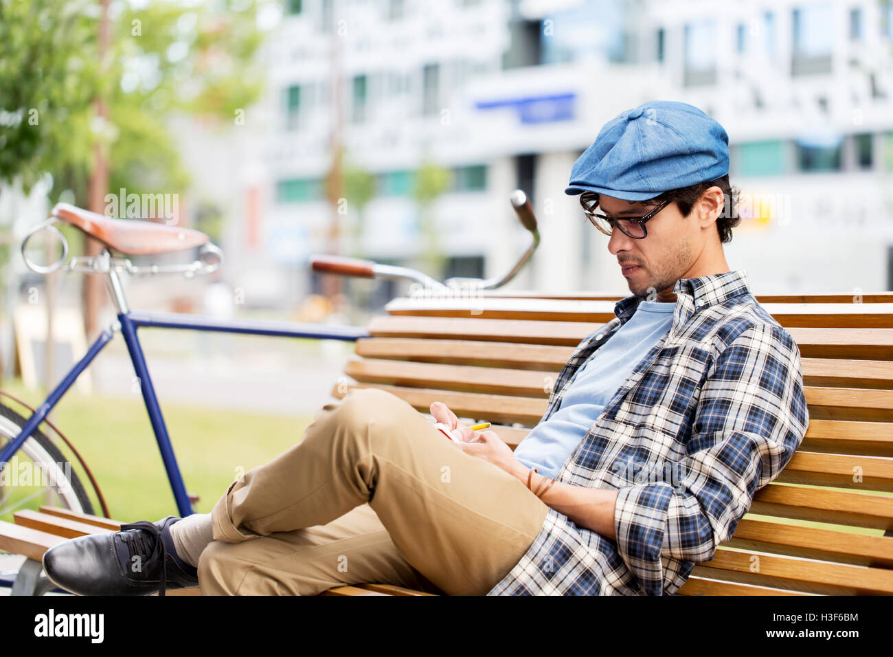 man with notebook or diary writing on city street Stock Photo - Alamy