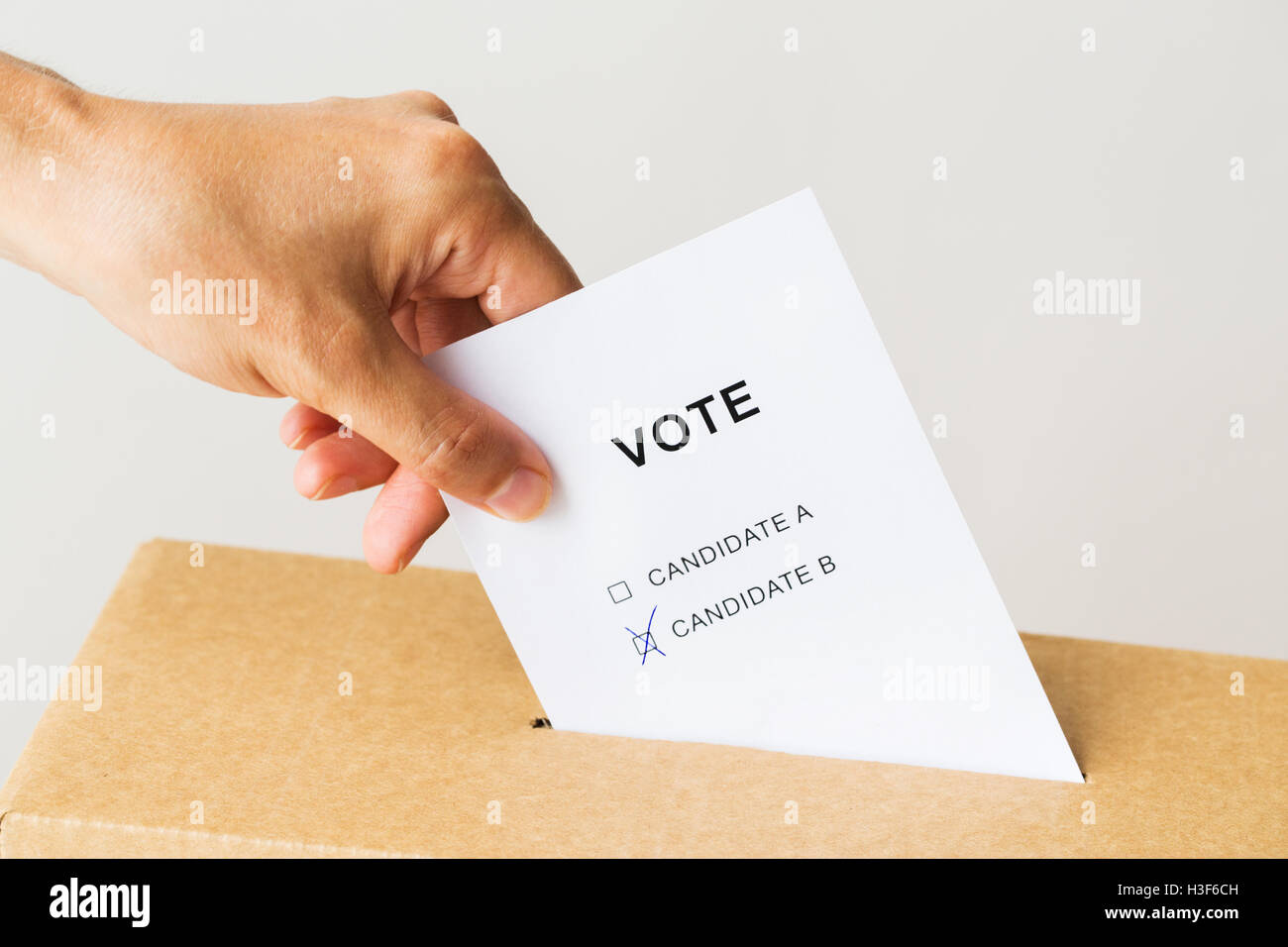 Hand putting vote into ballot box hi-res stock photography and images ...