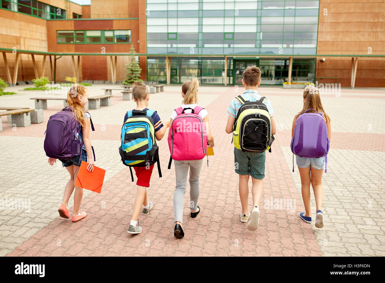 group of happy elementary school students walking Stock Photo - Alamy