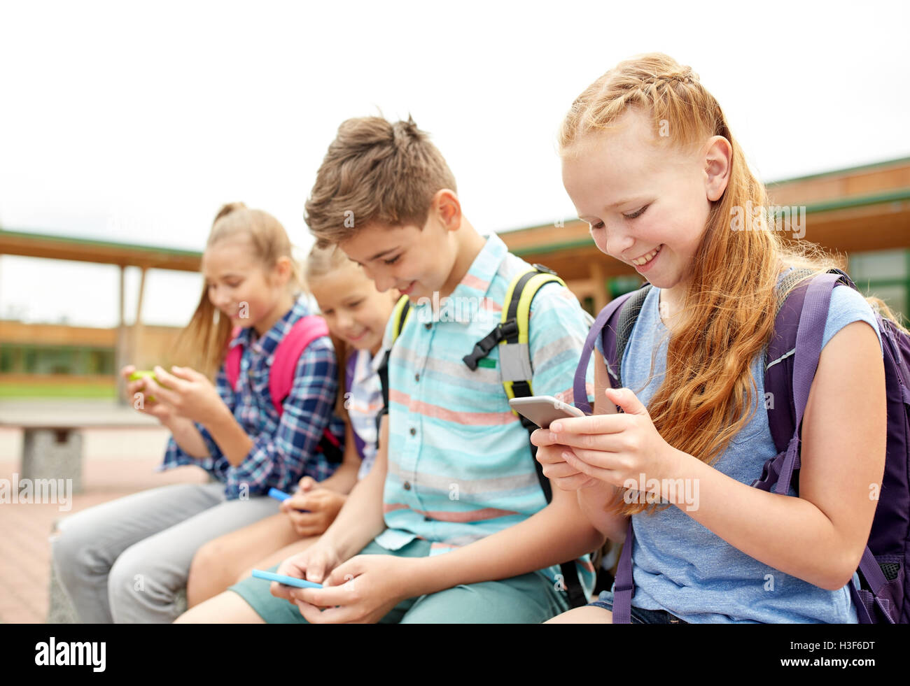 elementary school students with smartphones Stock Photo - Alamy