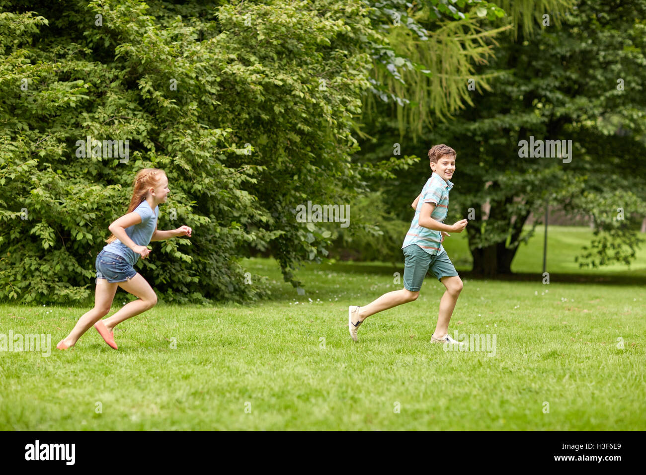 happy kids running and playing game outdoors Stock Photo - Alamy