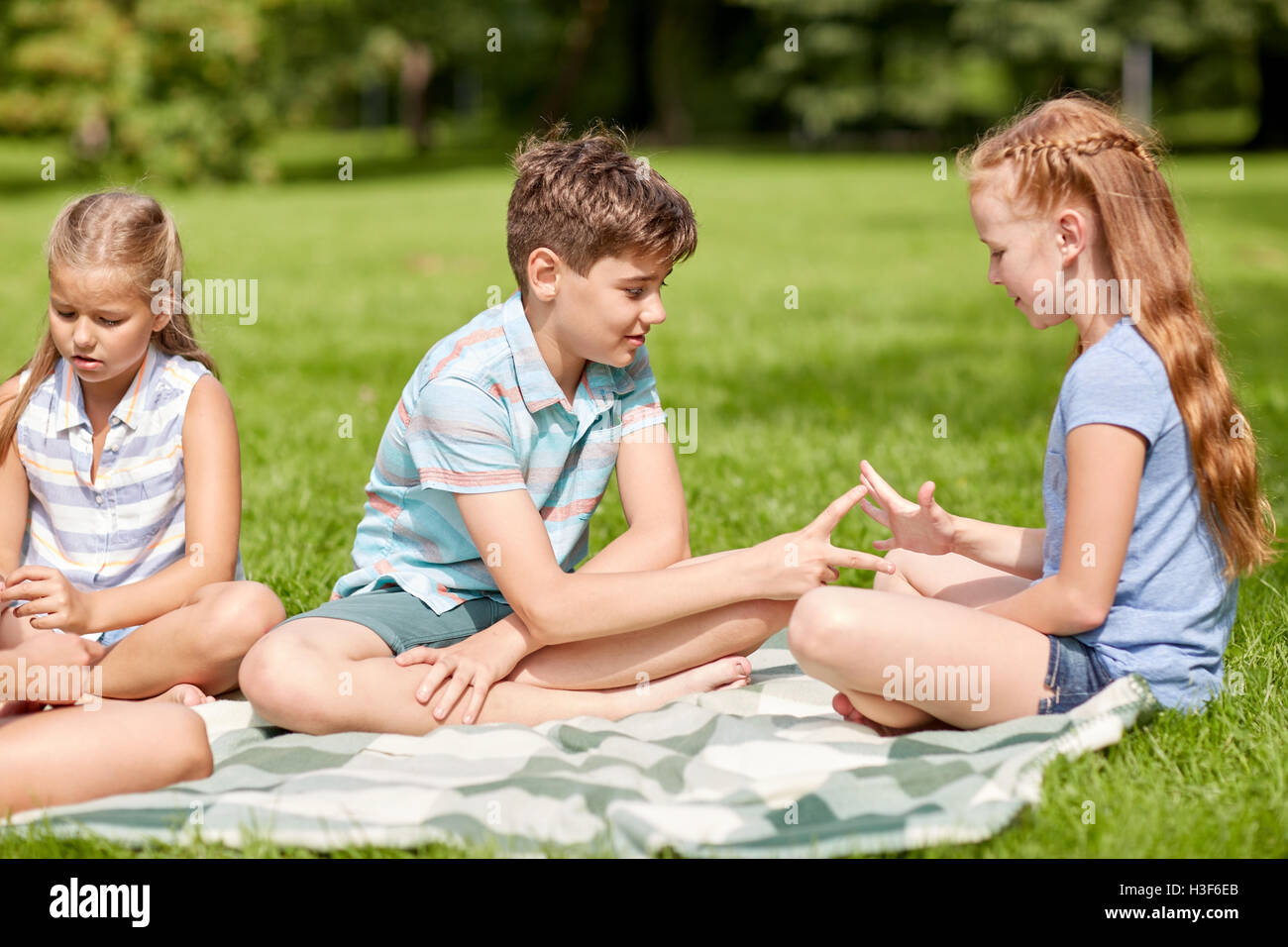 happy kids playing rock-paper-scissors game Stock Photo - Alamy
