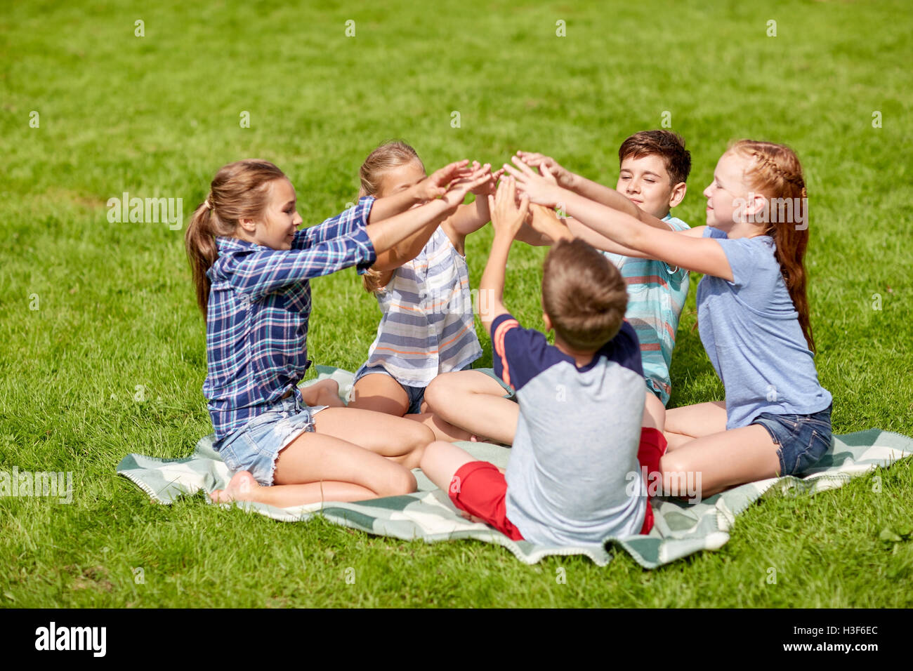 group of happy kids putting hands together Stock Photo - Alamy