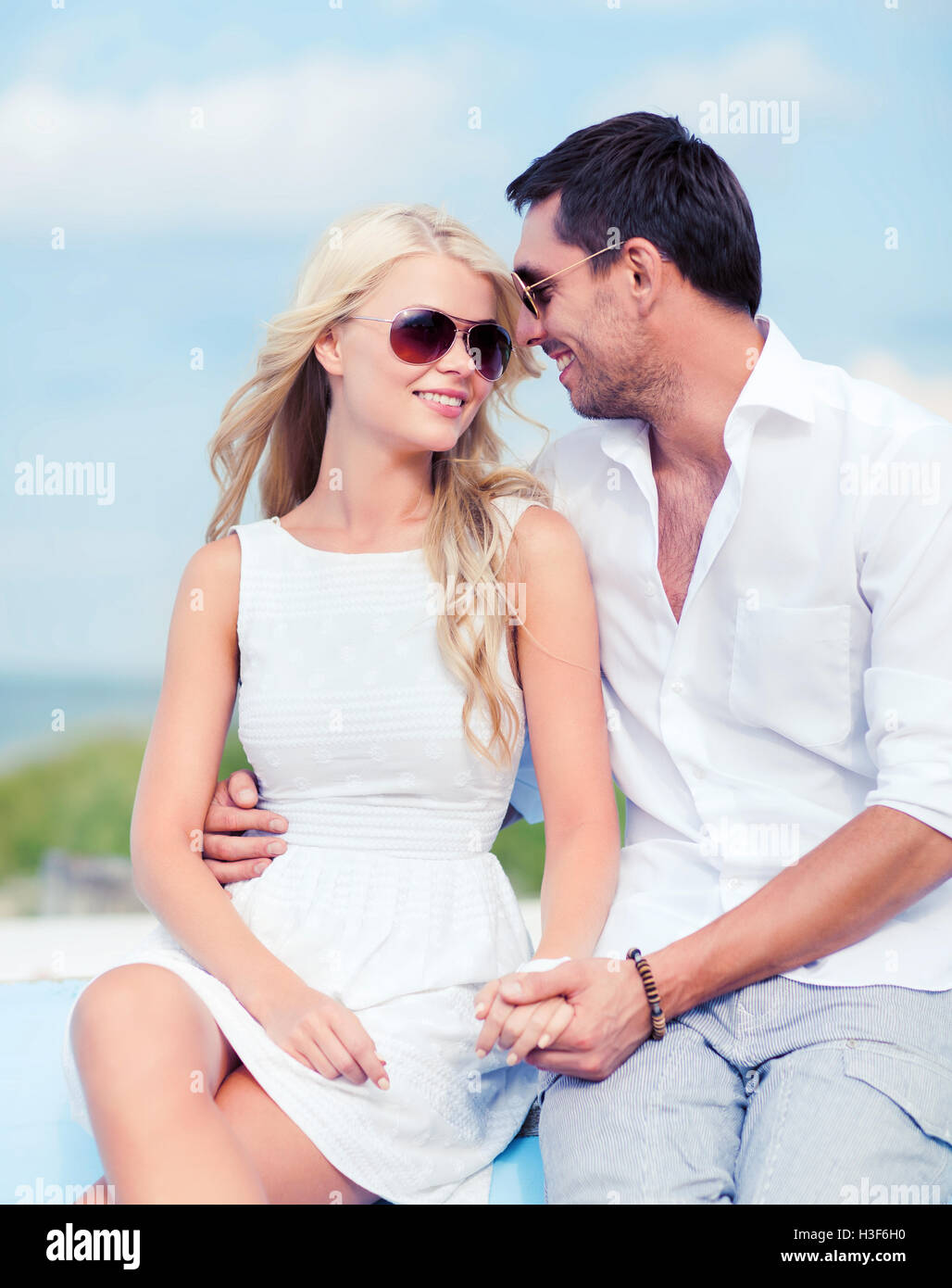 couple in shades at seaside Stock Photo - Alamy