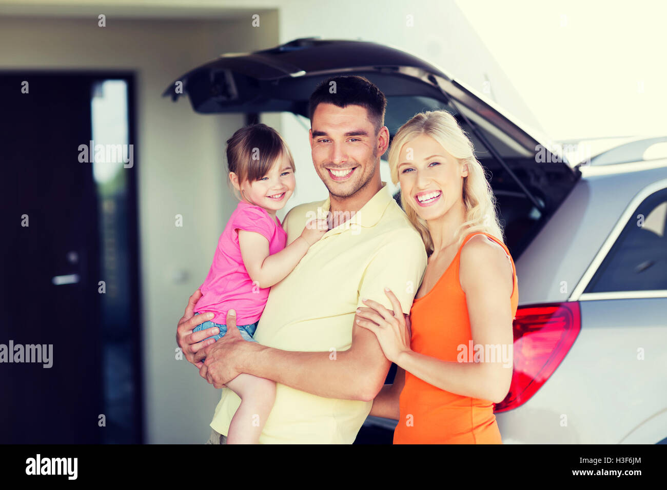happy family with hatchback car at home parking Stock Photo - Alamy
