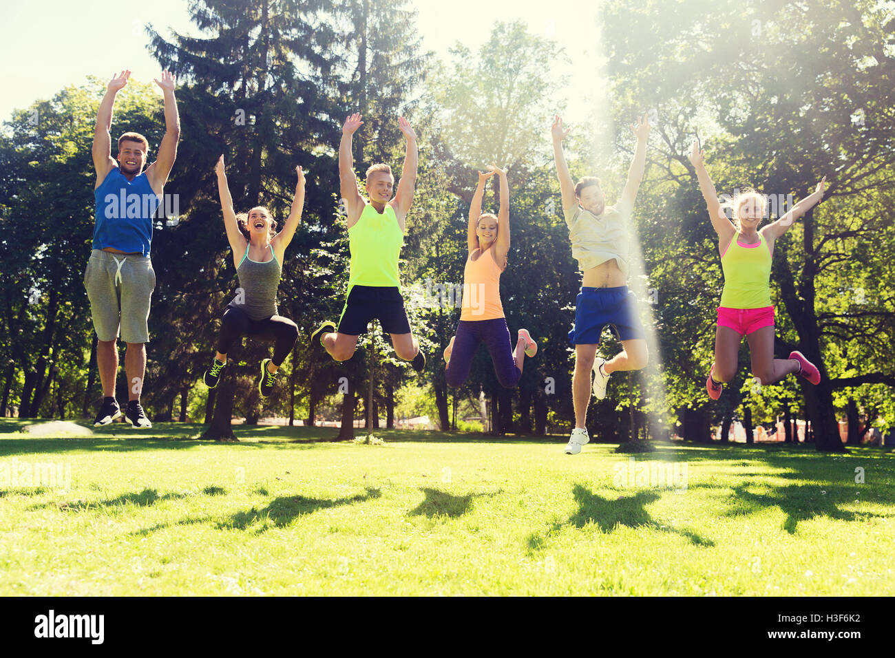 group of happy friends jumping high outdoors Stock Photo - Alamy