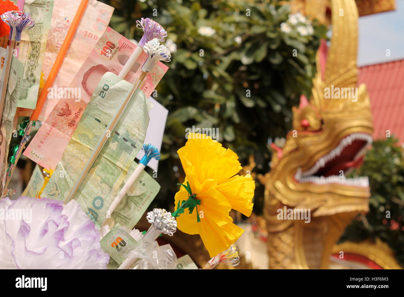 Money and flags adorn Thai Buddhist offering Stock Photo - Alamy
