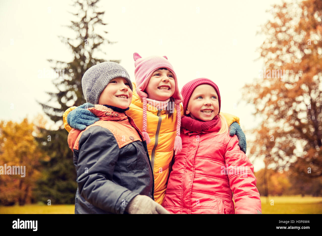 group of happy children hugging in autumn park Stock Photo - Alamy
