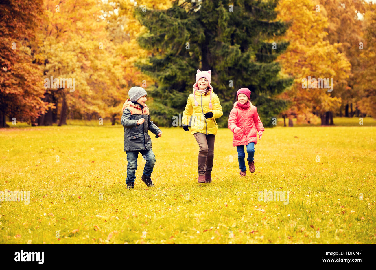 group of happy little kids running outdoors Stock Photo - Alamy