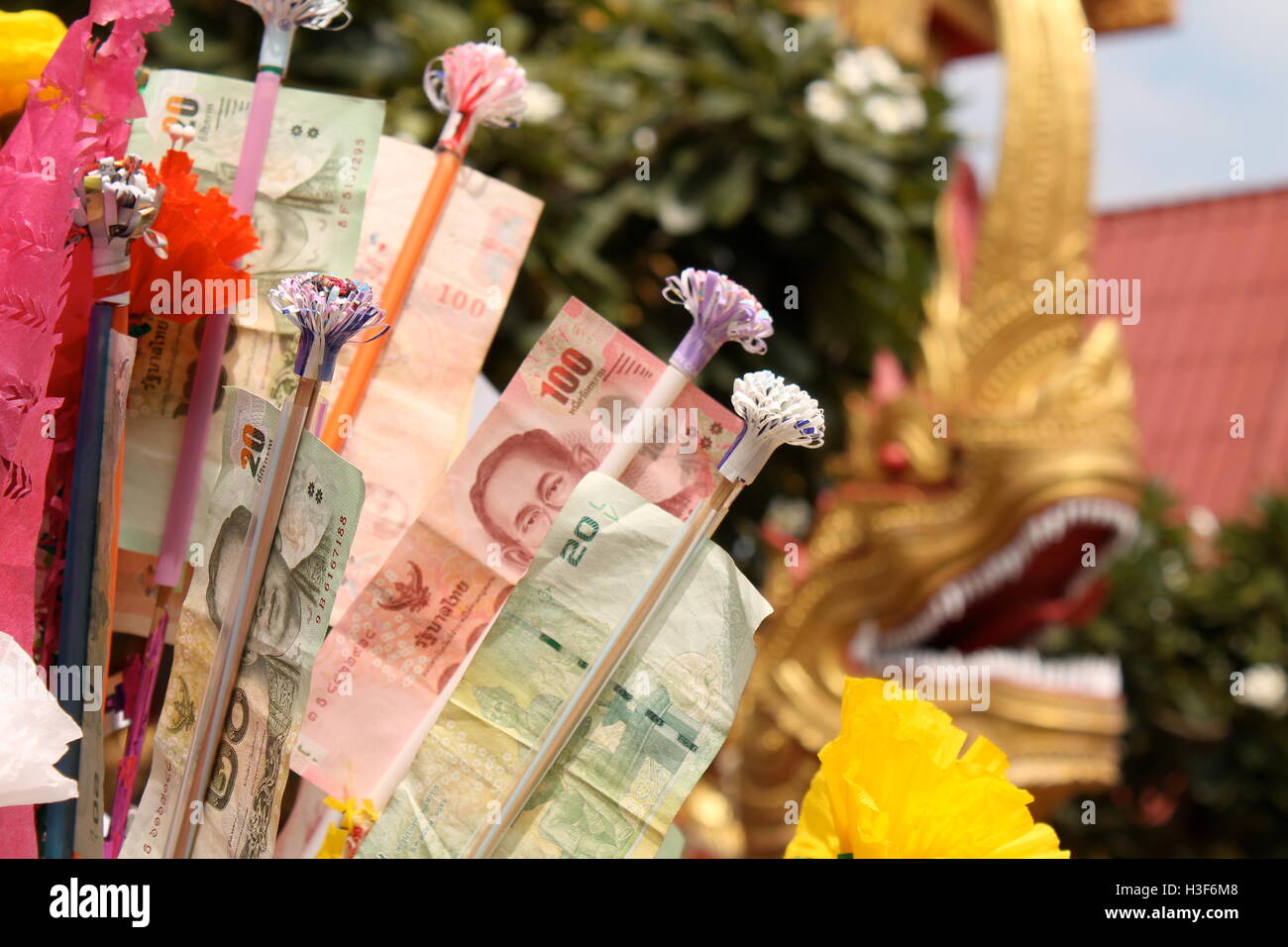 Money and flags adorn Thai Buddhist offering Stock Photo - Alamy