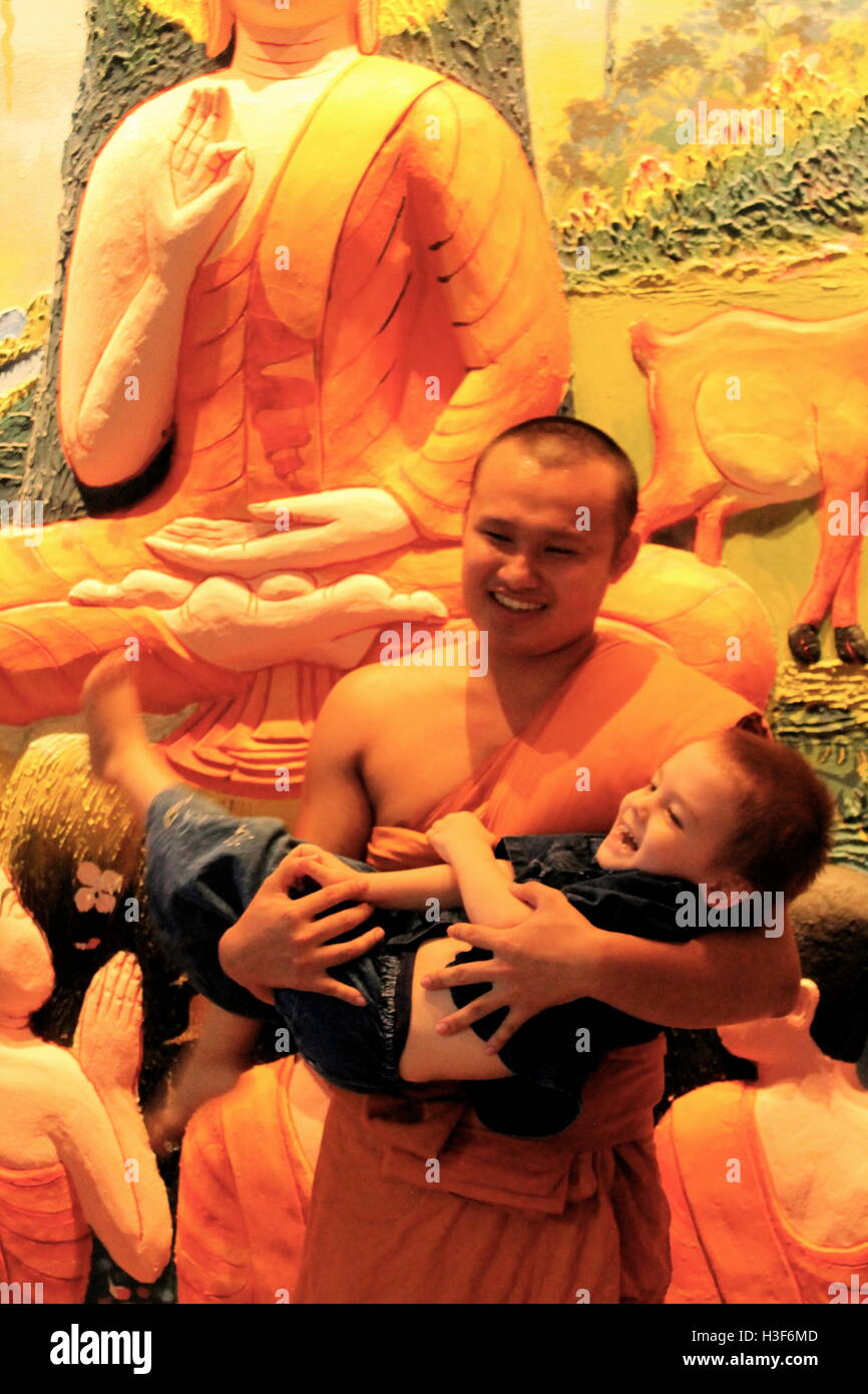 Buddhist monk playing with young boy Stock Photo - Alamy