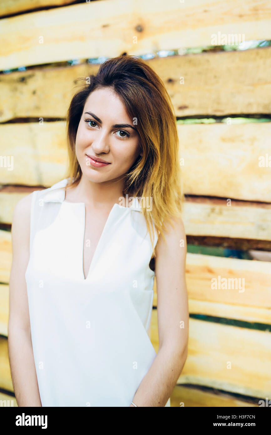 girl posing against background of a wooden wall Stock Photo - Alamy