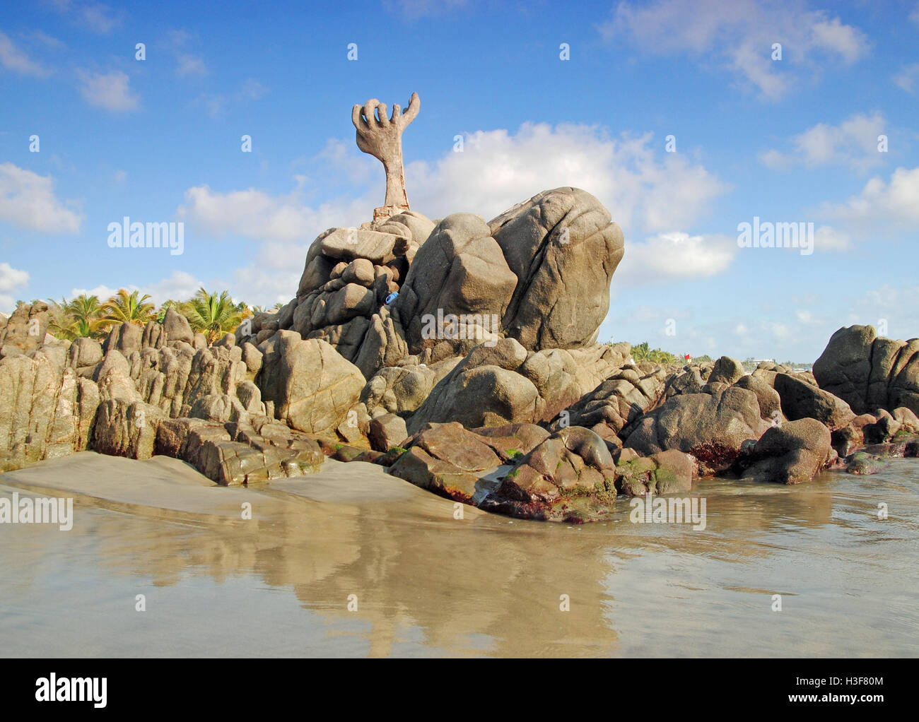 Sand sculpture in the shape of a hand on the beach, Puerto Escondido ...