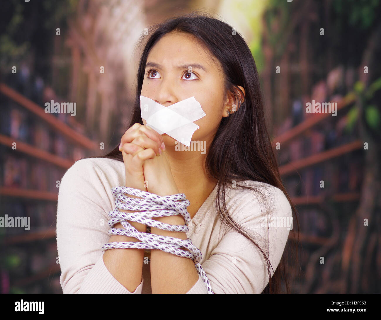 Young Brunette Woman Tied Up With Rope Around Wrists And White Tape