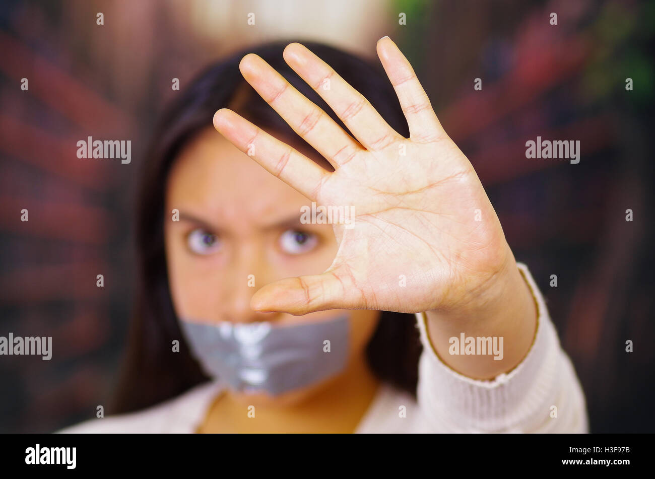 Young Brunette Woman Wearing White Sweater Gagged With Duct Tape