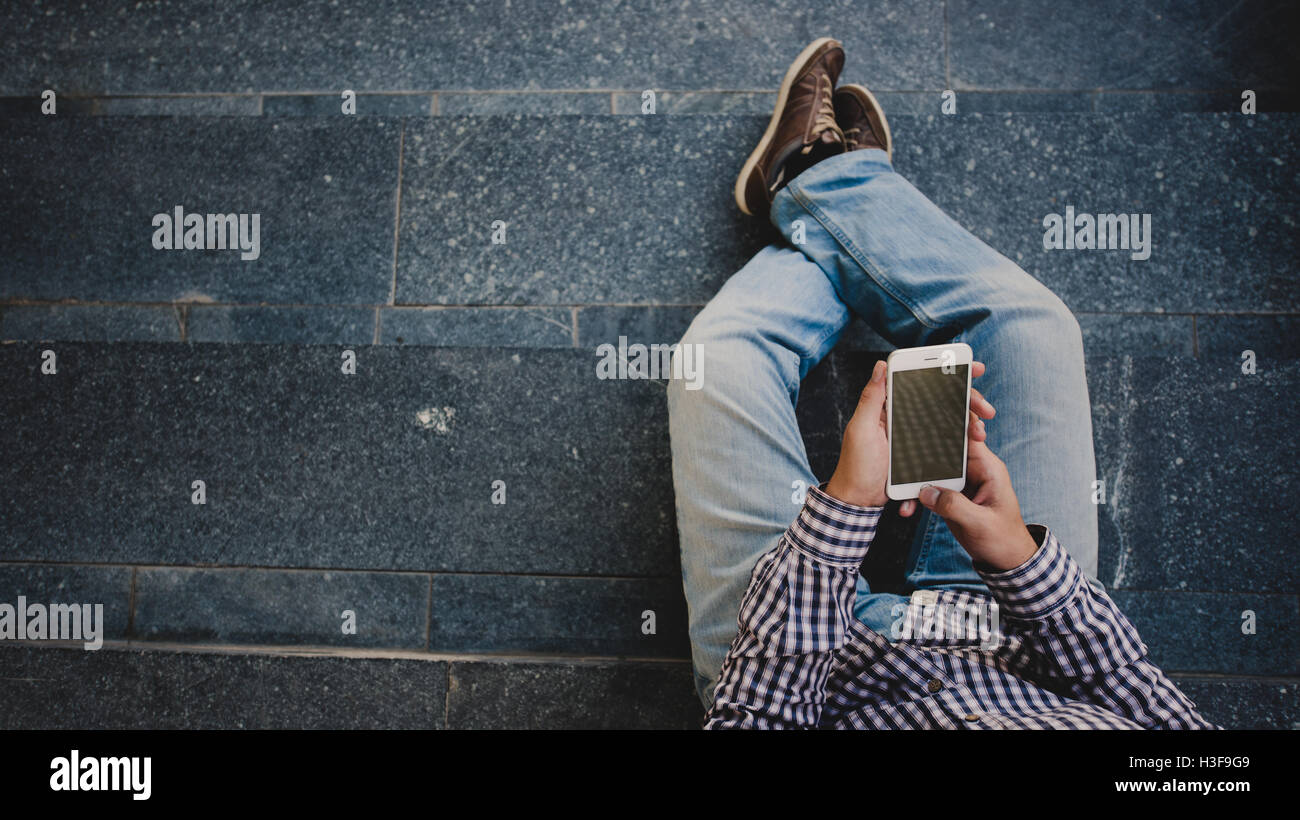 Student using cell phone sitting steps hi-res stock photography and ...