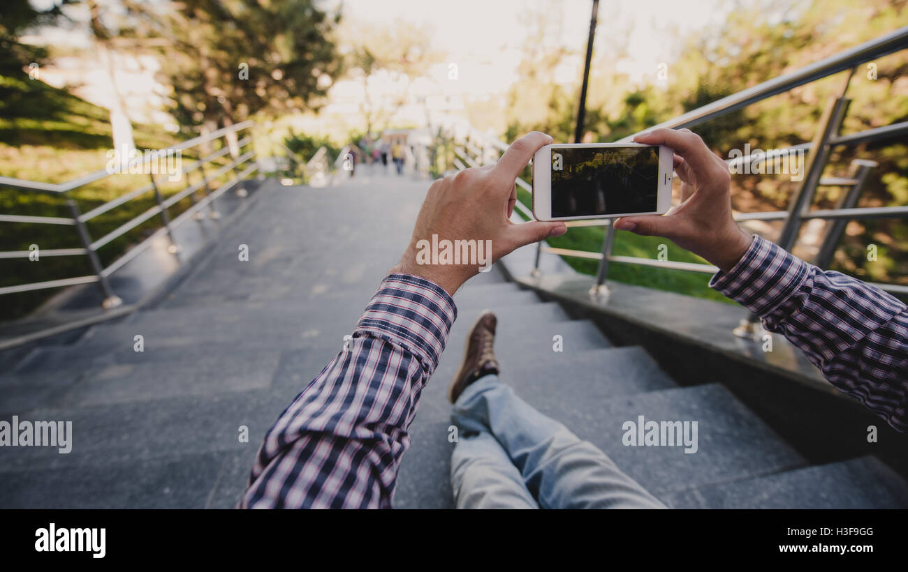 Close up a man taking photos of nice view with his smart phone while ...