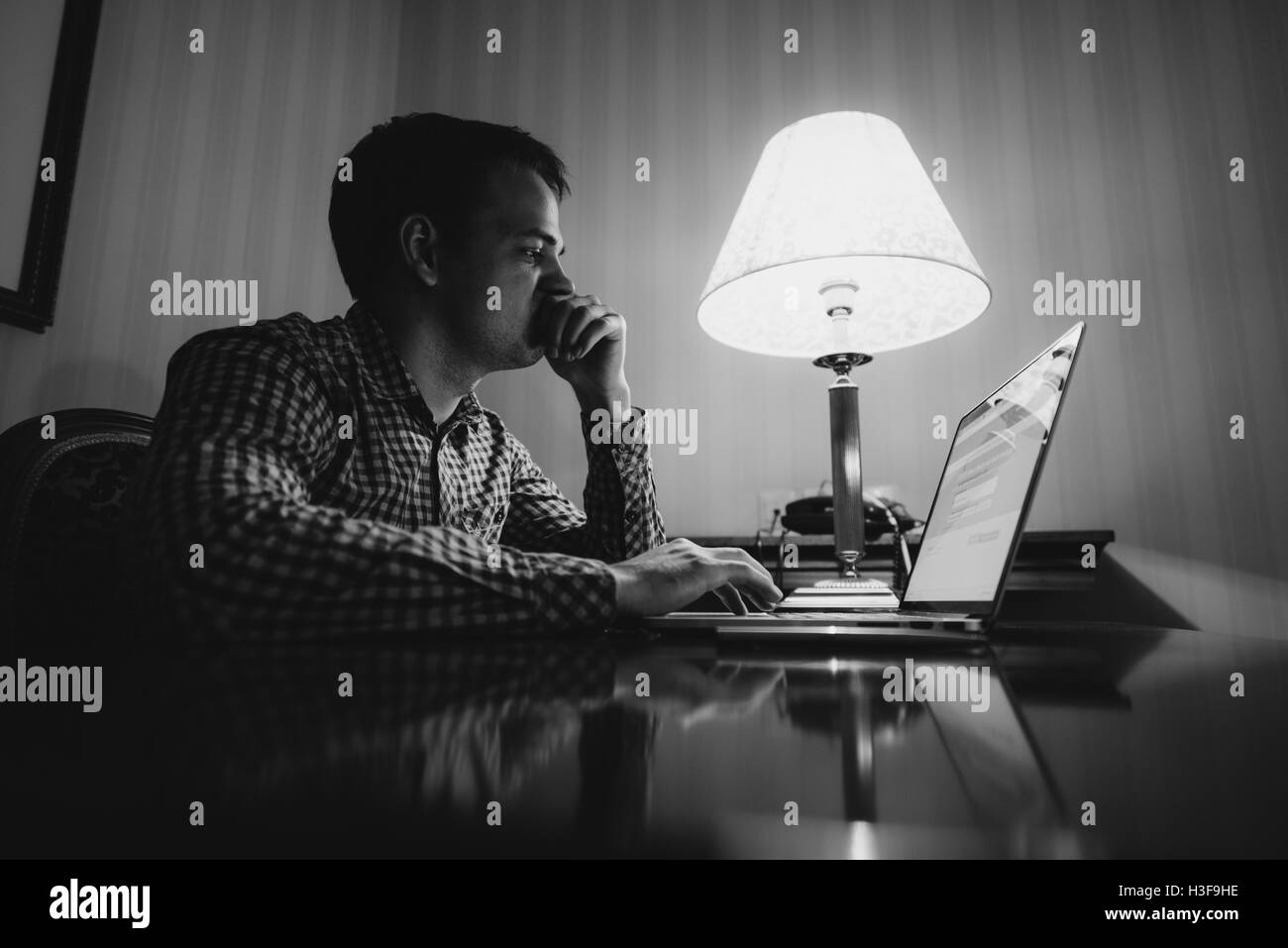 frustrated young business man working on laptop computer at office ...
