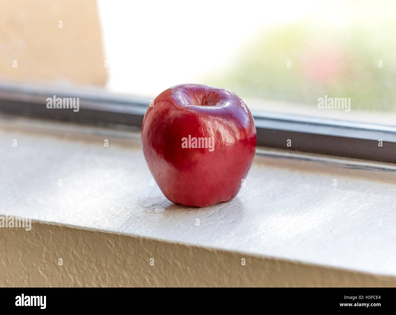Red Delicious apple sitting on windows sill of kitchen Stock Photo - Alamy