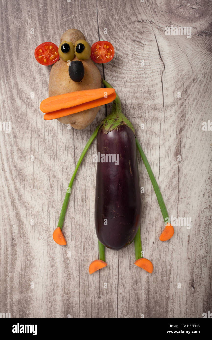 Funny monkey made of vegetables on wooden background Stock Photo - Alamy