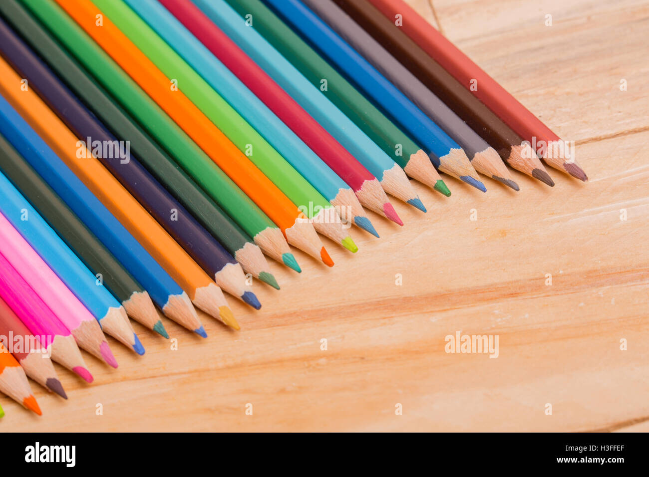 Wooden colorful pencils, on wooden table Stock Photo - Alamy