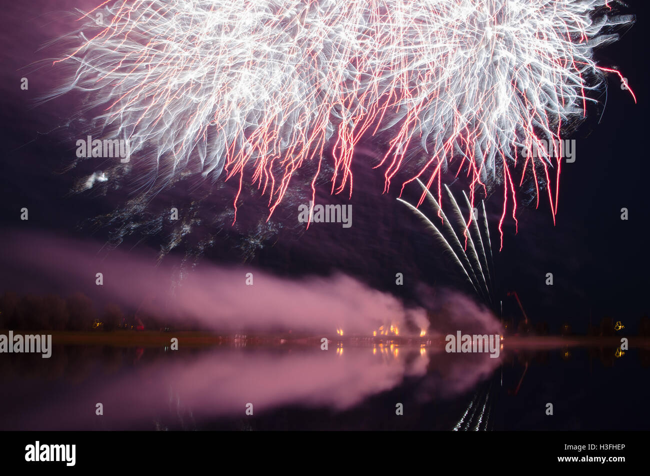 Fireworks and smoke reflecting on the water Stock Photo - Alamy