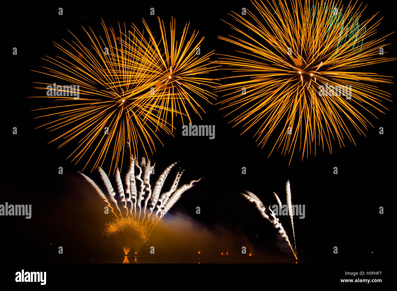 Orange fireworks bursts at night Stock Photo - Alamy