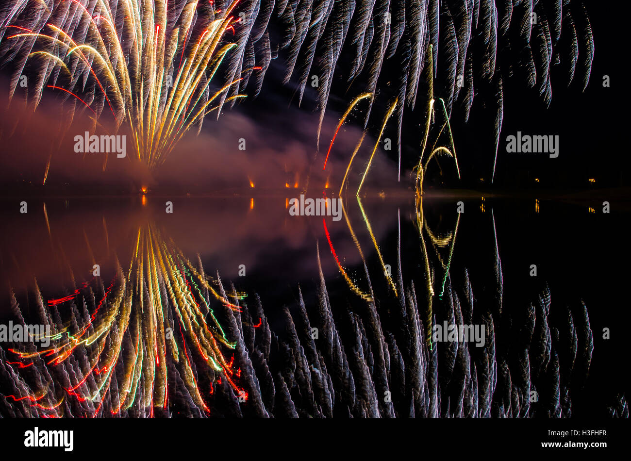 Fireworks display reflections on the water at night Stock Photo - Alamy