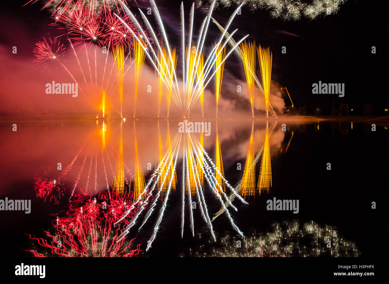 Fireworks, display reflecting on water at night Stock Photo - Alamy