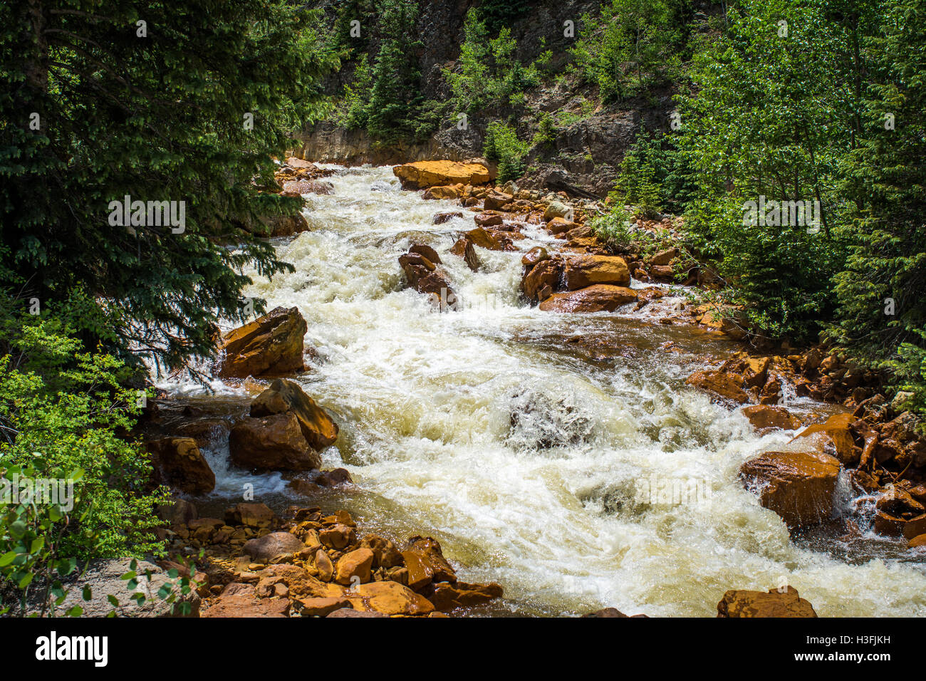 Mountain River with yellow mining deposits near Ouray Colorado, USA ...