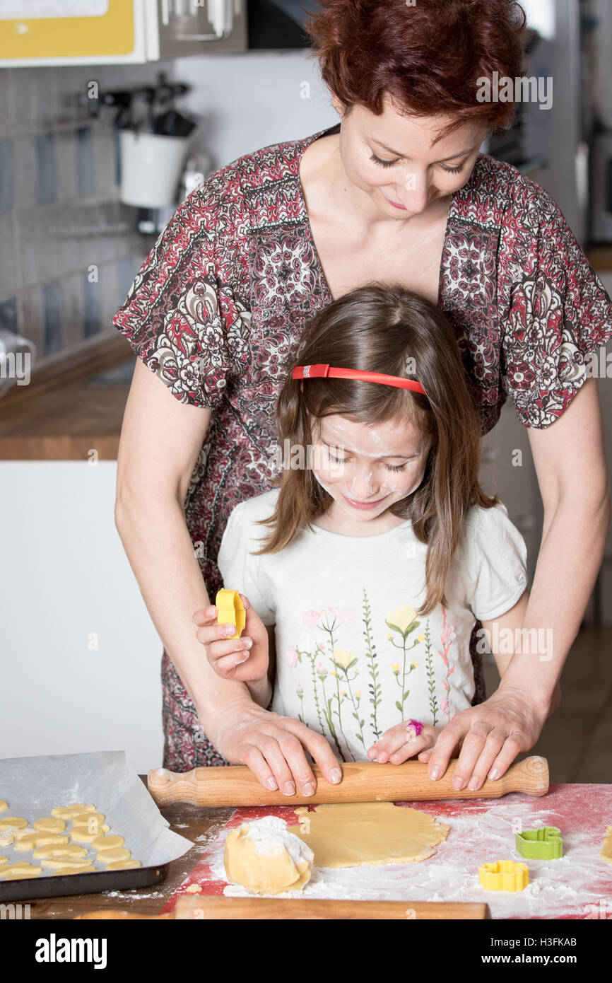 Mother and daughter enjoying baking cookies together Stock Photo - Alamy