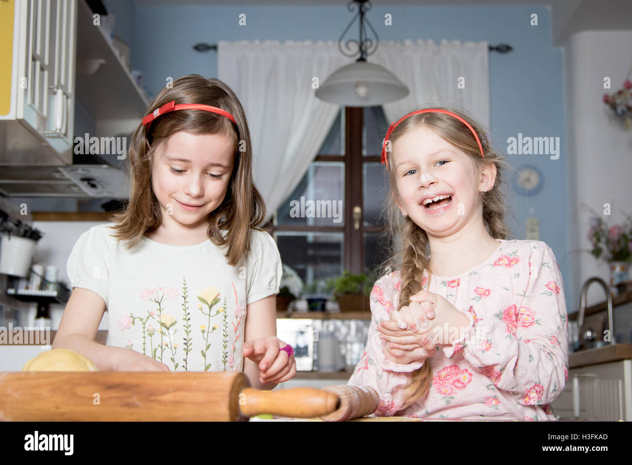 Girls baking and having fun preparing pastry for Christmas cookies ...