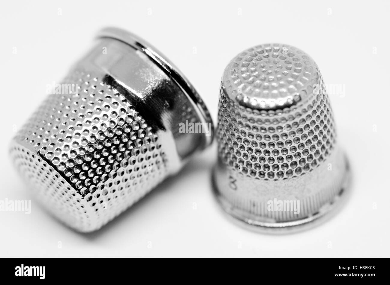 Thimbles resting next to each other Stock Photo - Alamy