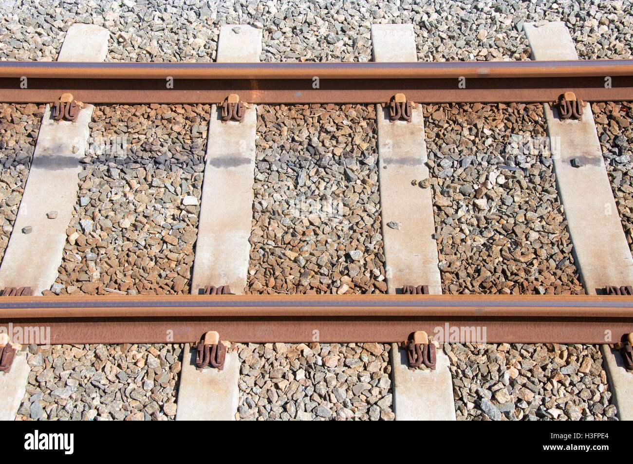 Abstract of railway lines with rusted steel beams and railroad ties ...