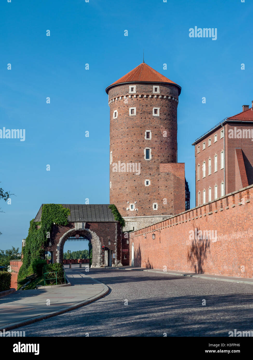 Medieval Gothic Sandomierska Tower, entrance gate and defensive wall at ...