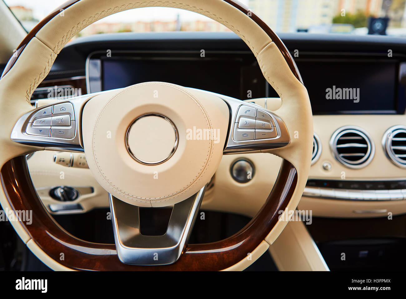 Luxury car Interior. Steering wheel and dashboard Stock Photo - Alamy