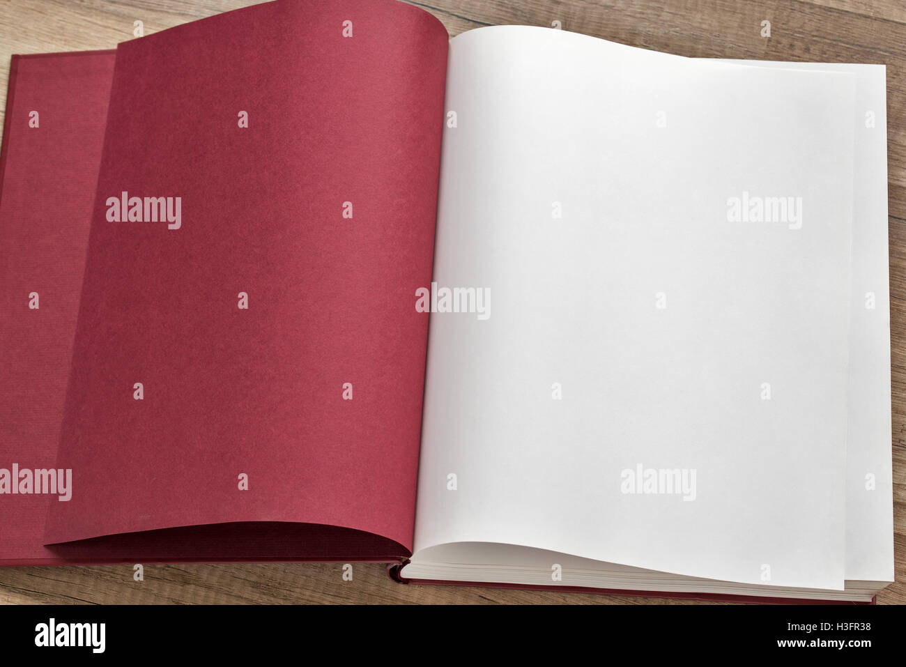 Open red book on the table Stock Photo - Alamy