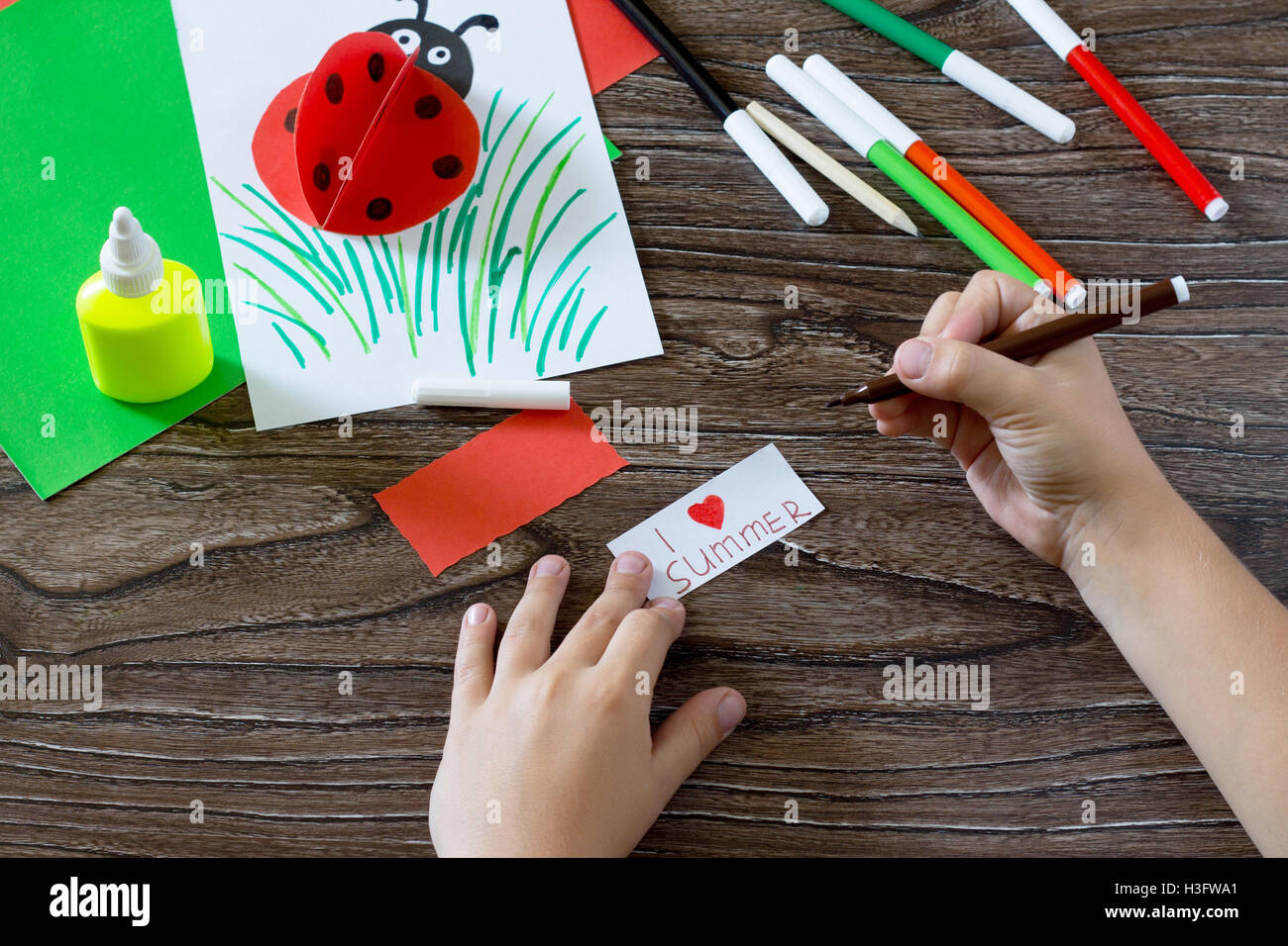 Child paper writes that the details I love summer. The child makes a ...