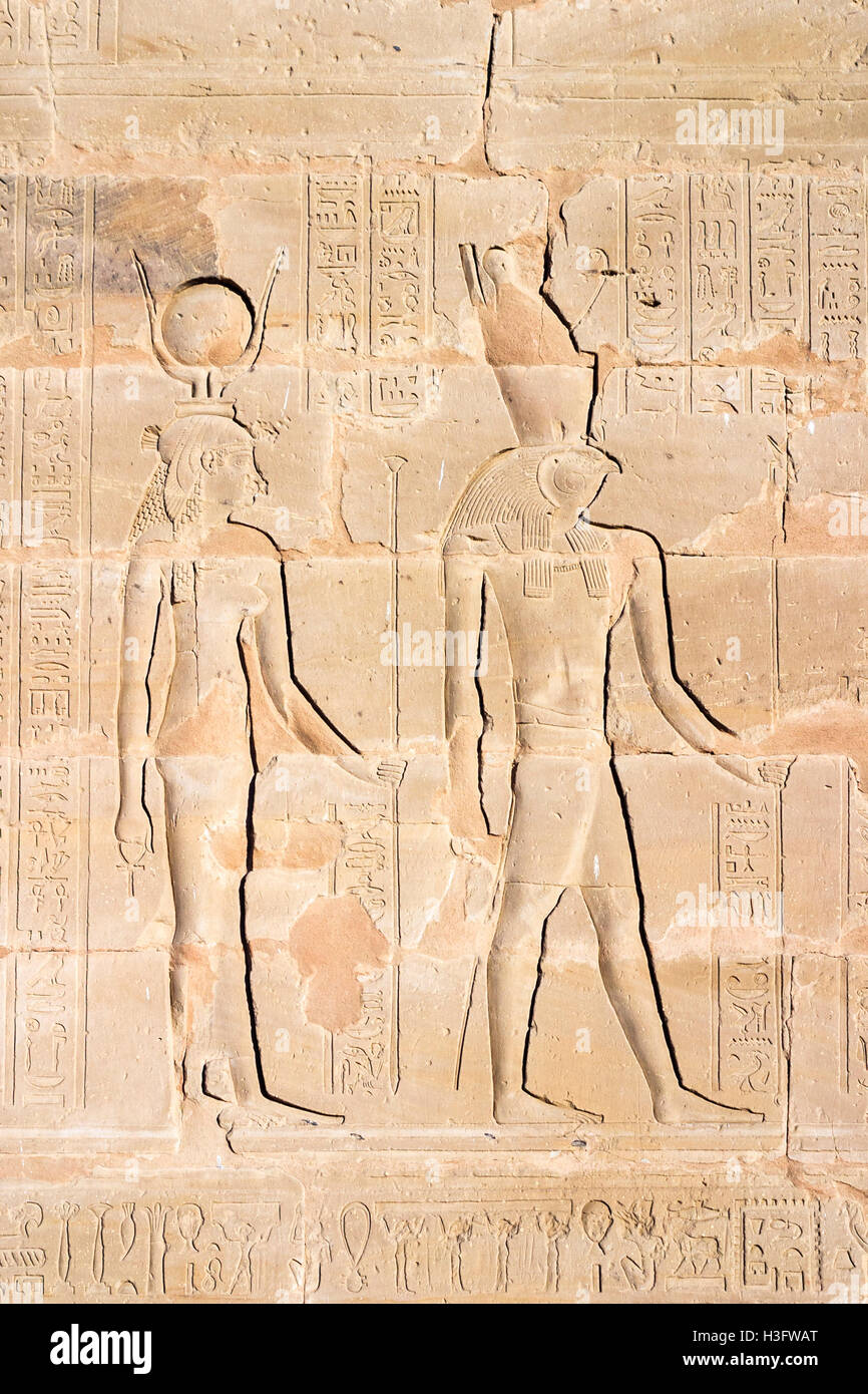 Wall reliefs including the falcon-headed god Horus and his goddess wife ...