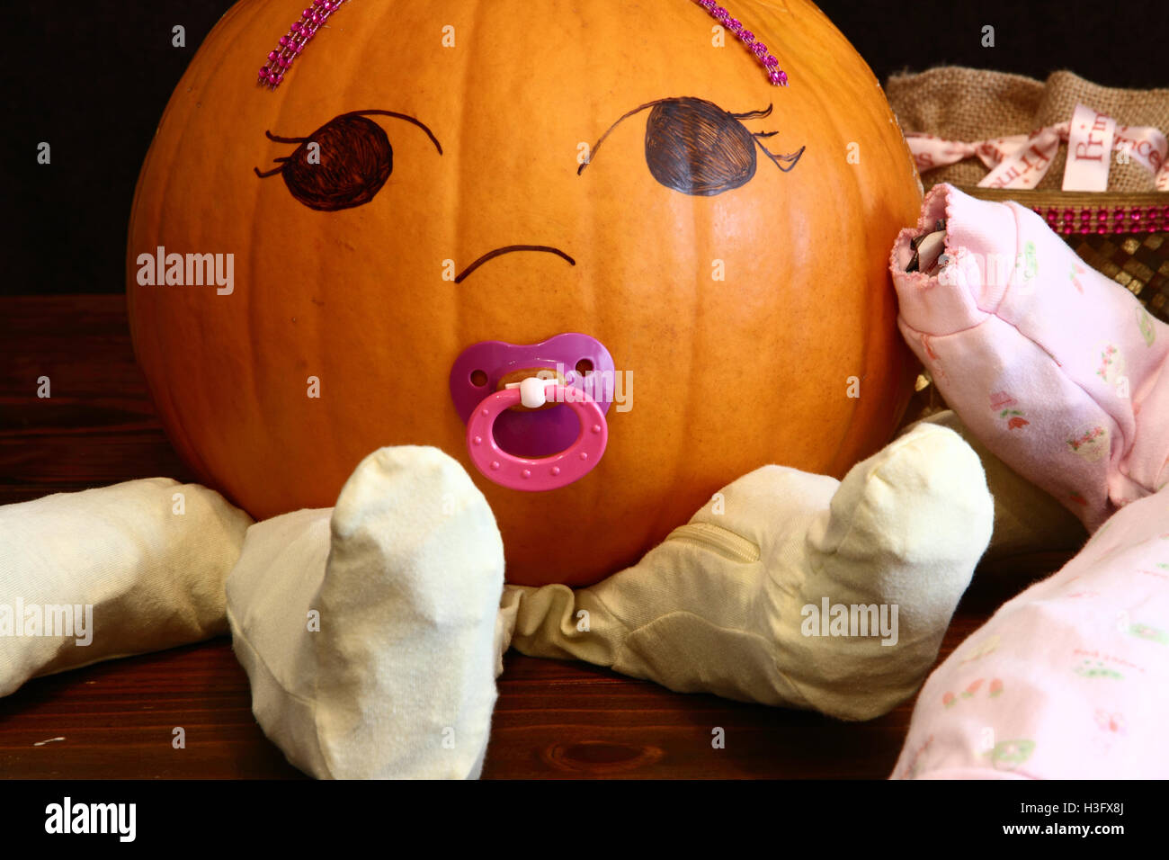 Closeup look at a pumpkin baby with pacifier Stock Photo - Alamy