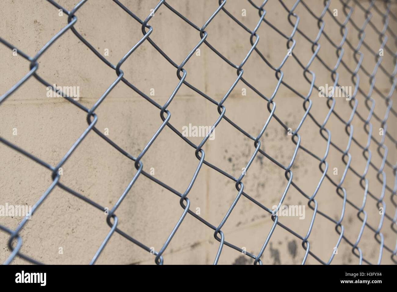 Fence from steel mesh on grunge cement wall backgroud Stock Photo - Alamy
