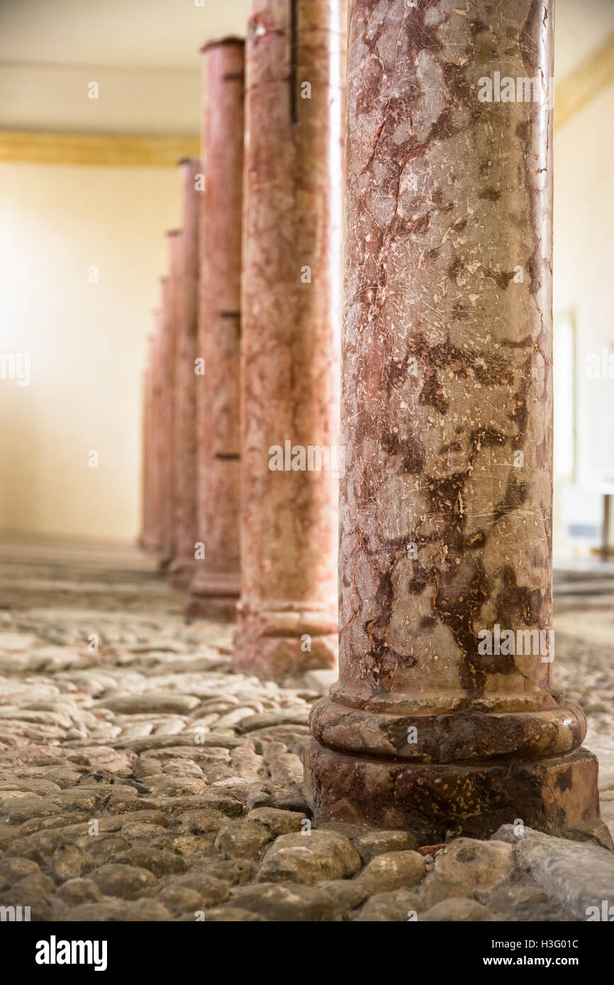 Antique red marble columns resting on stone floor Stock Photo - Alamy