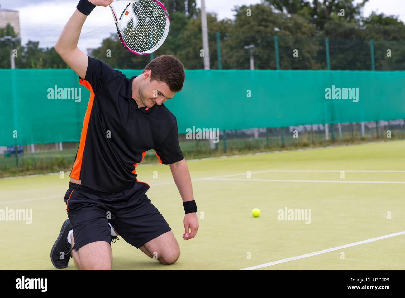 Angry male tennis player wearing a sportswear is going to break a ...