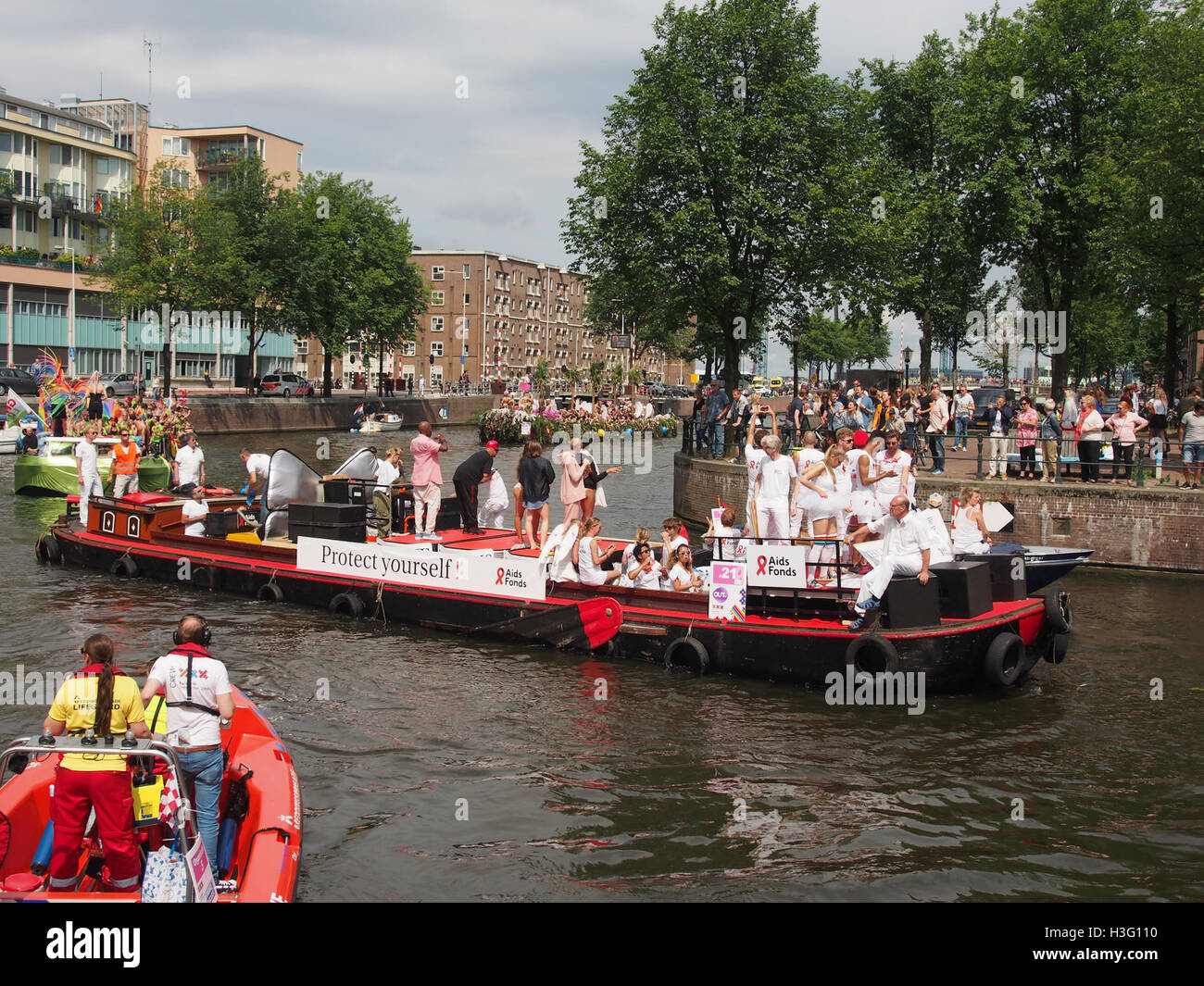 The image shows a vibrant scene from the Pride Canal Parade in 2016 ...