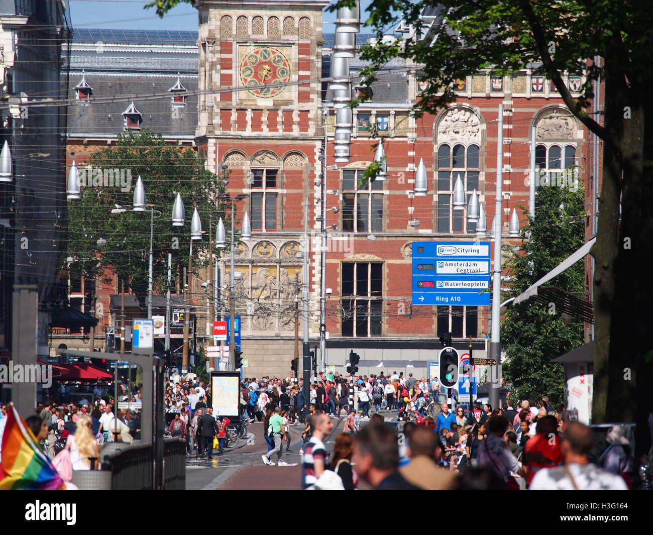 This photograph captures a bustling scene of the Damrak, a major street ...