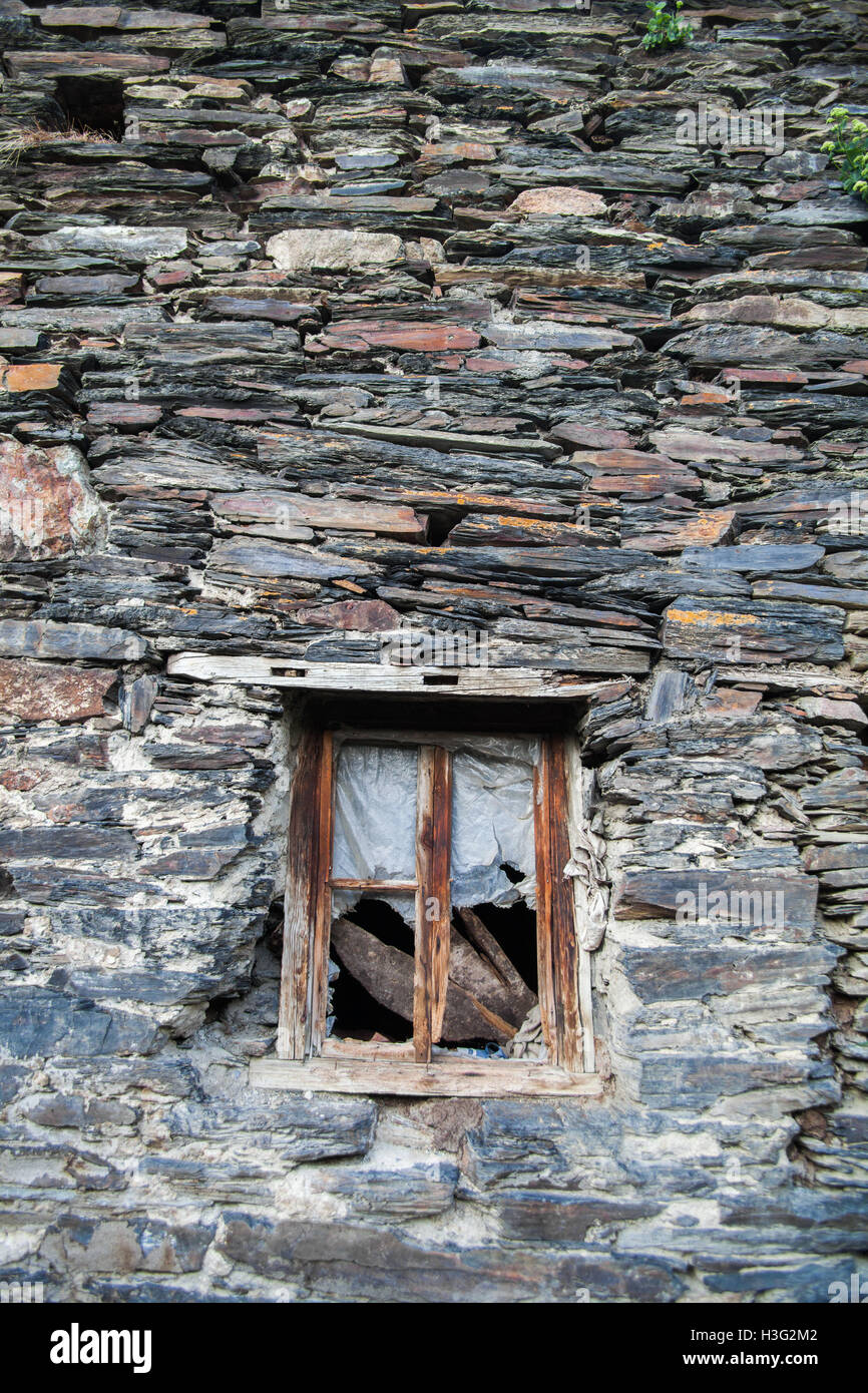 Color image of a broken window on a stone wall Stock Photo - Alamy