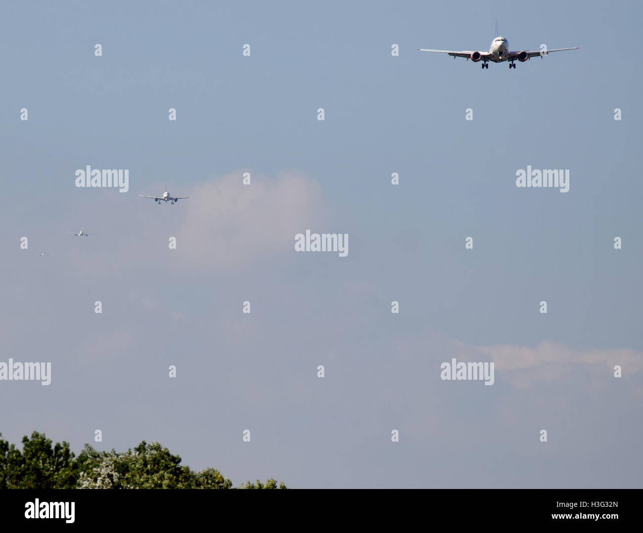 A photograph showing four aircraft approaching London Heathrow's runway ...