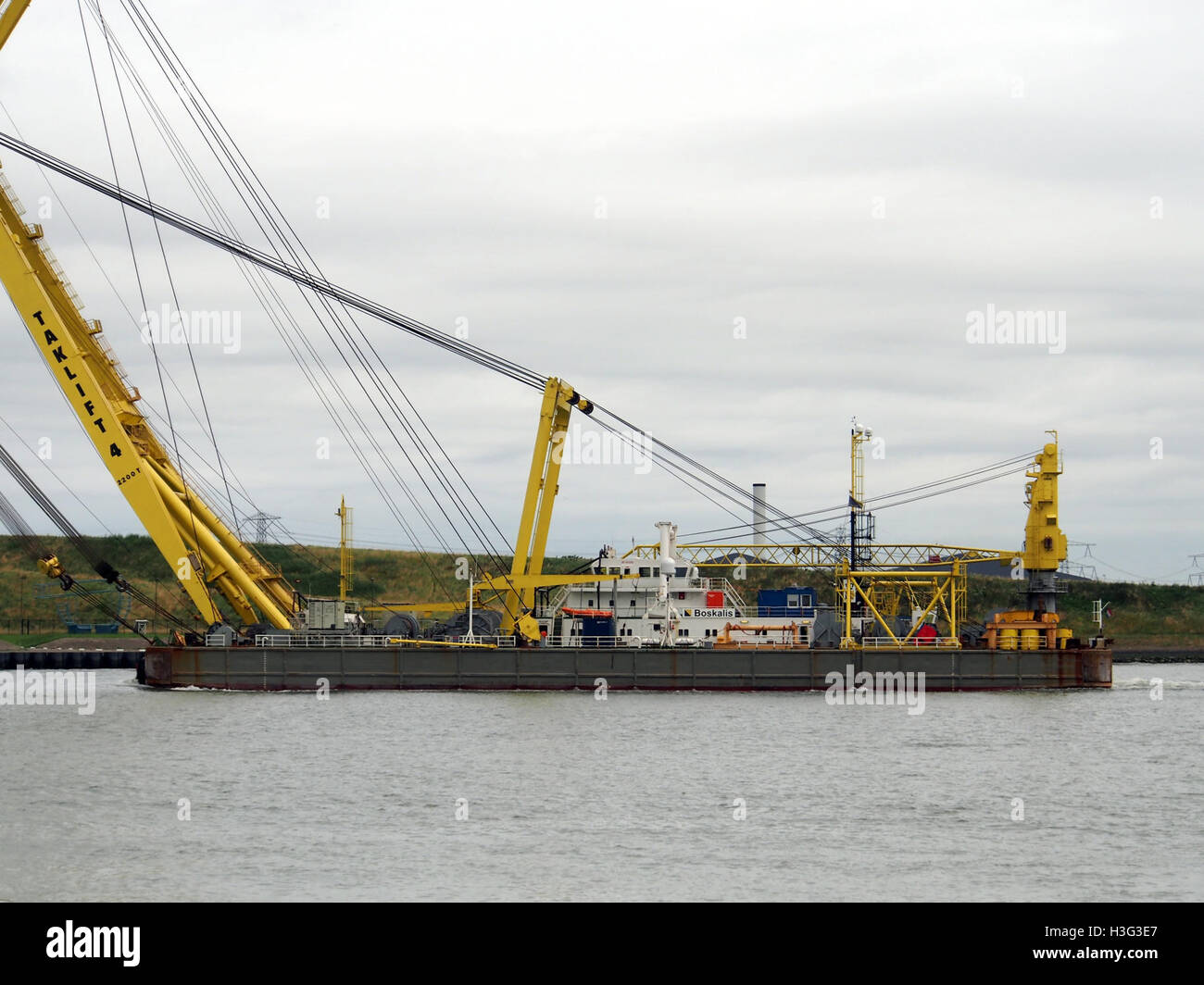 The image depicts the TAKLIFT 4, a floating sheerleg crane at the Port ...