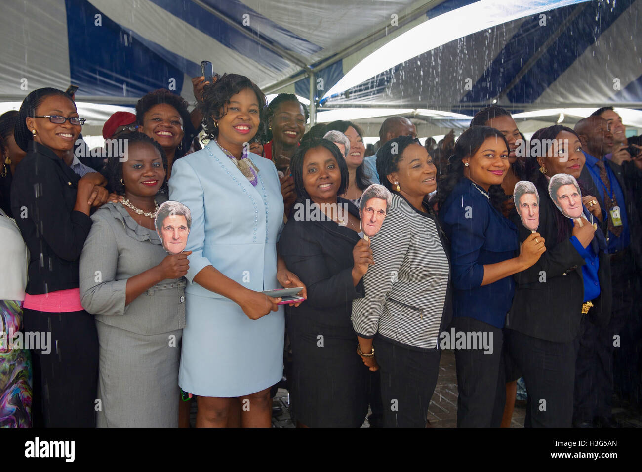 Staffers from U.S. Embassy Abuja carry signs bearing the face of U.S ...